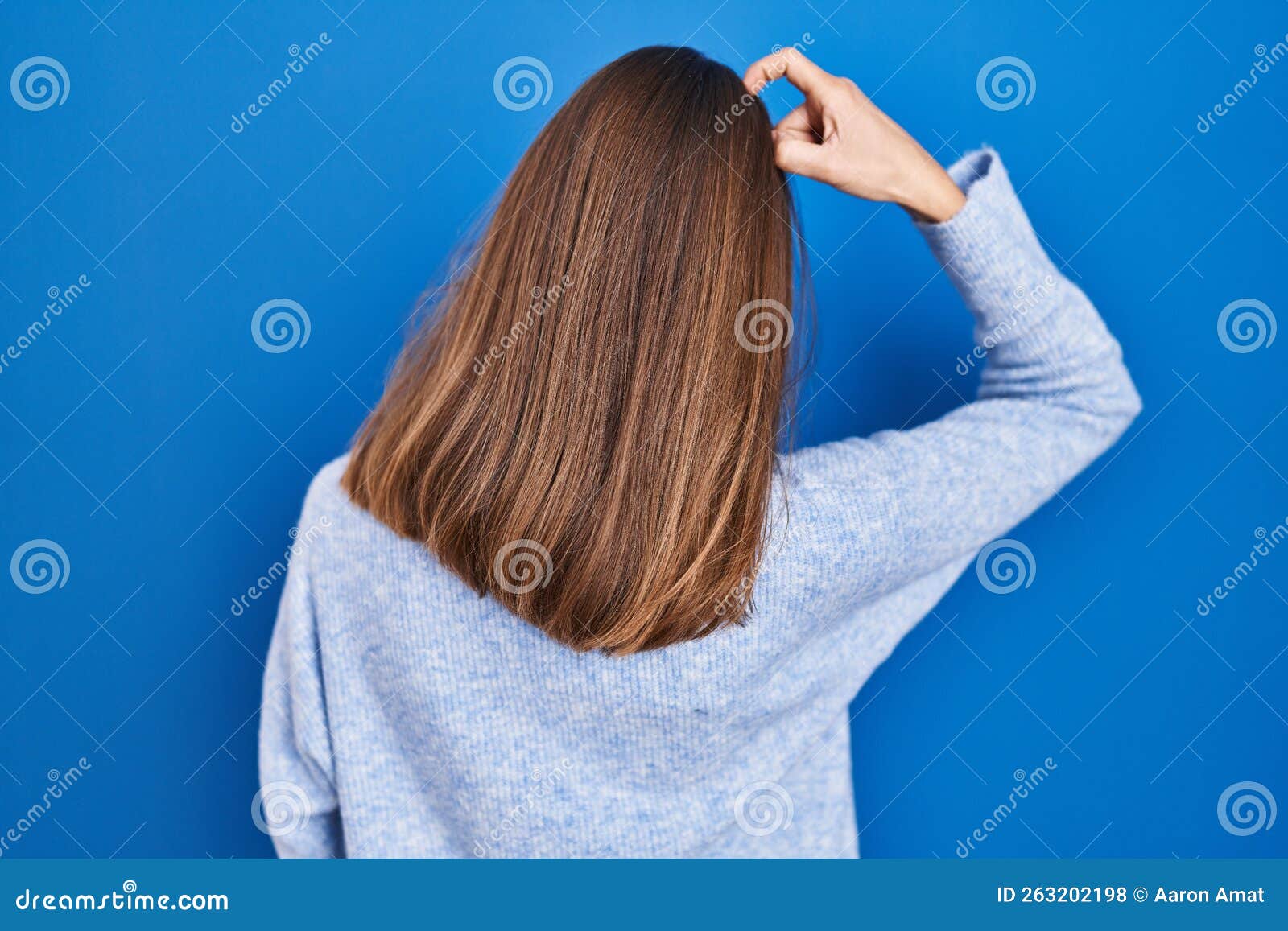 Young Woman Standing Over Blue Background Backwards Thinking about ...