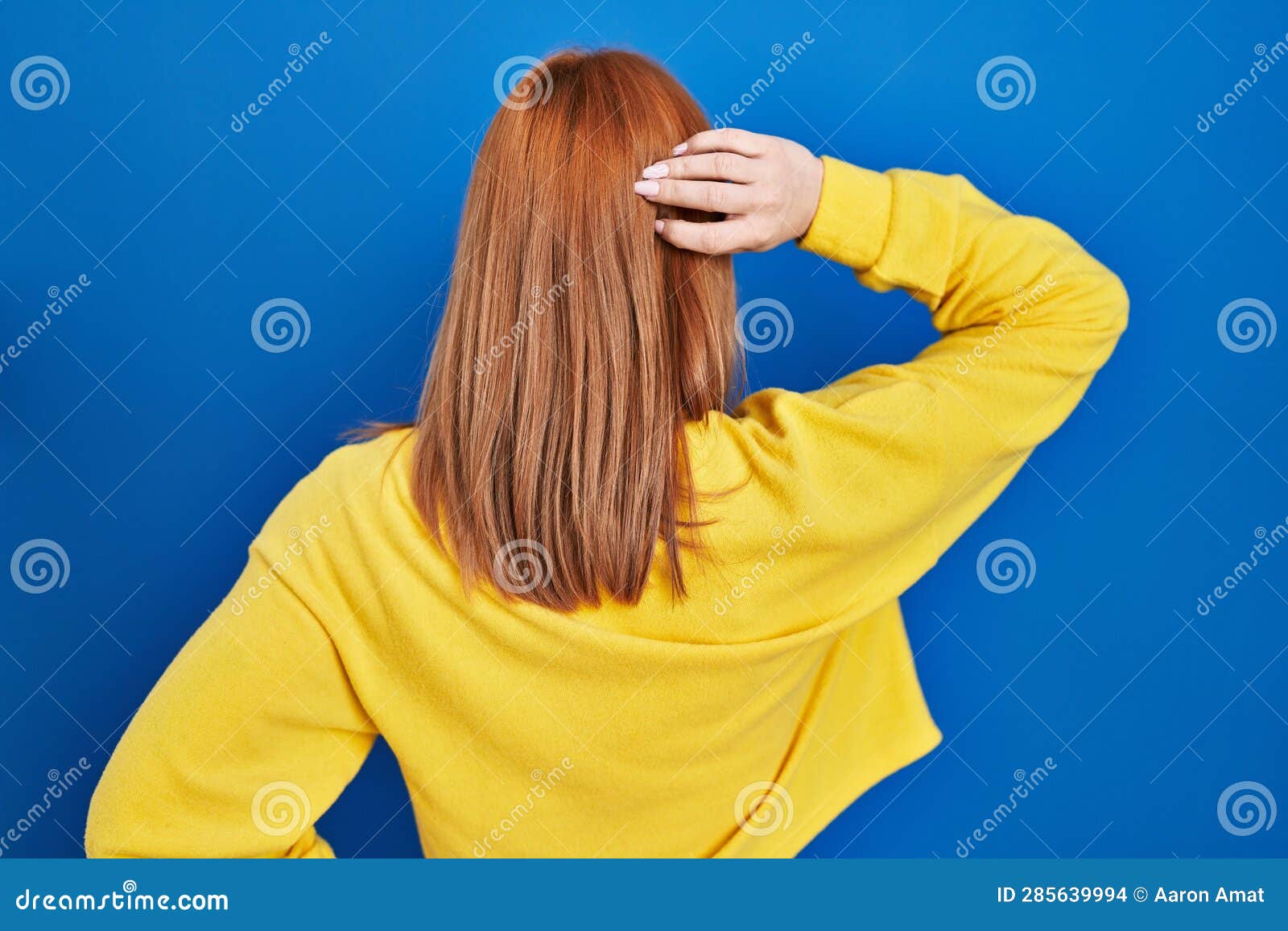 Young Woman Standing Over Blue Background Backwards Thinking about ...
