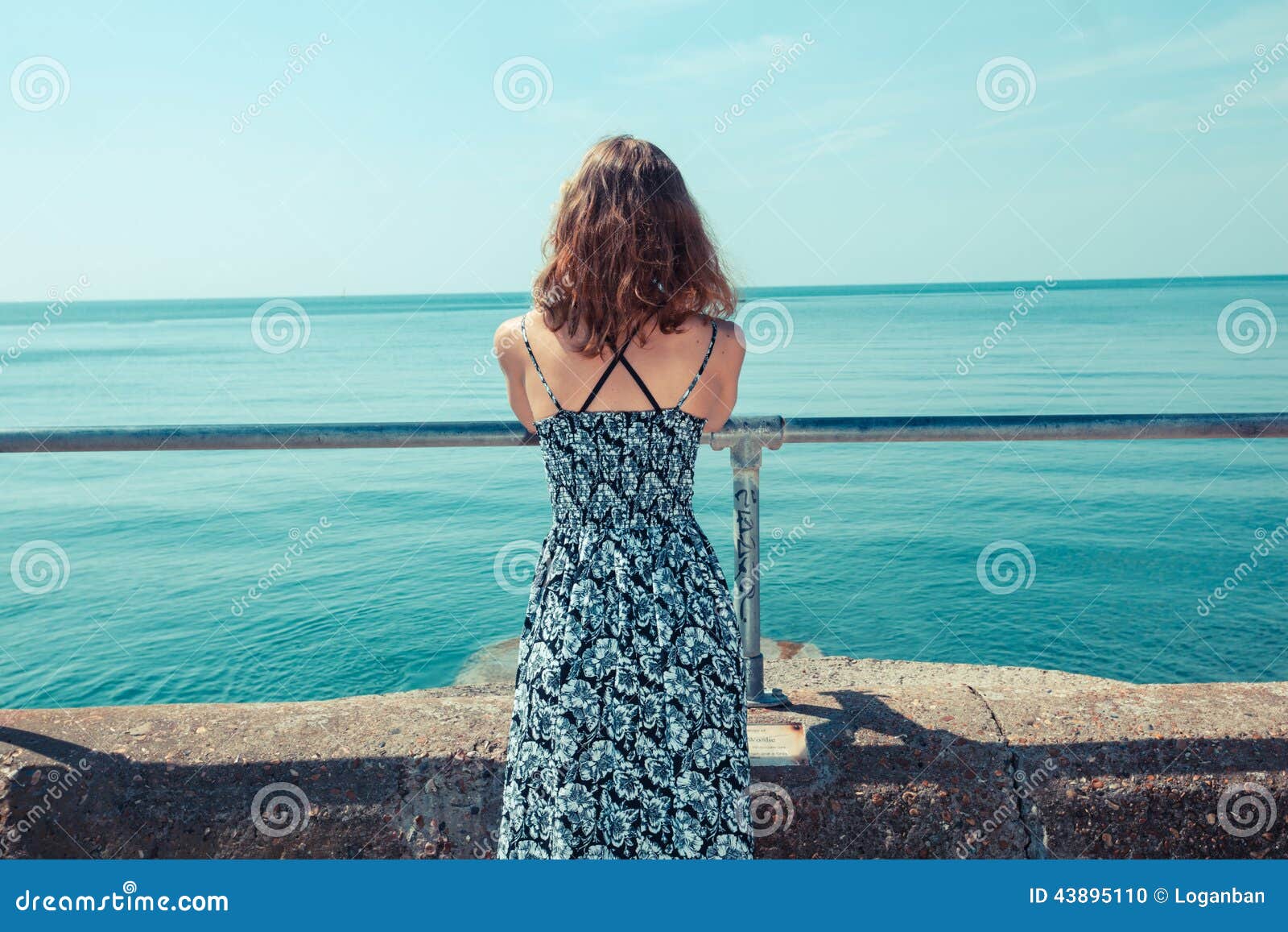 Young Woman Standing on a Pier by the Ocean Stock Photo - Image of ...