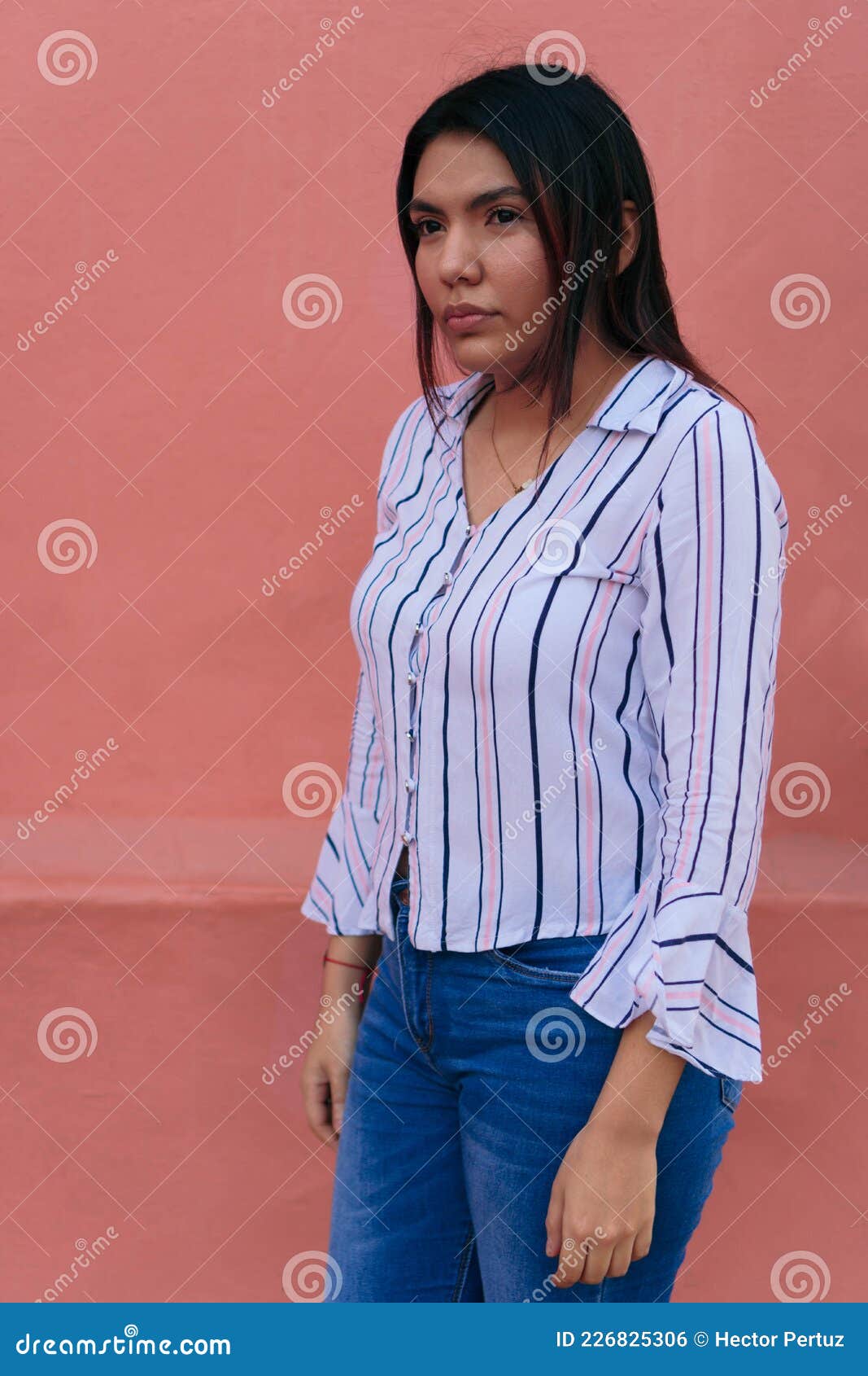 Young Woman Standing Staring Blankly with a Serious Expression Stock ...