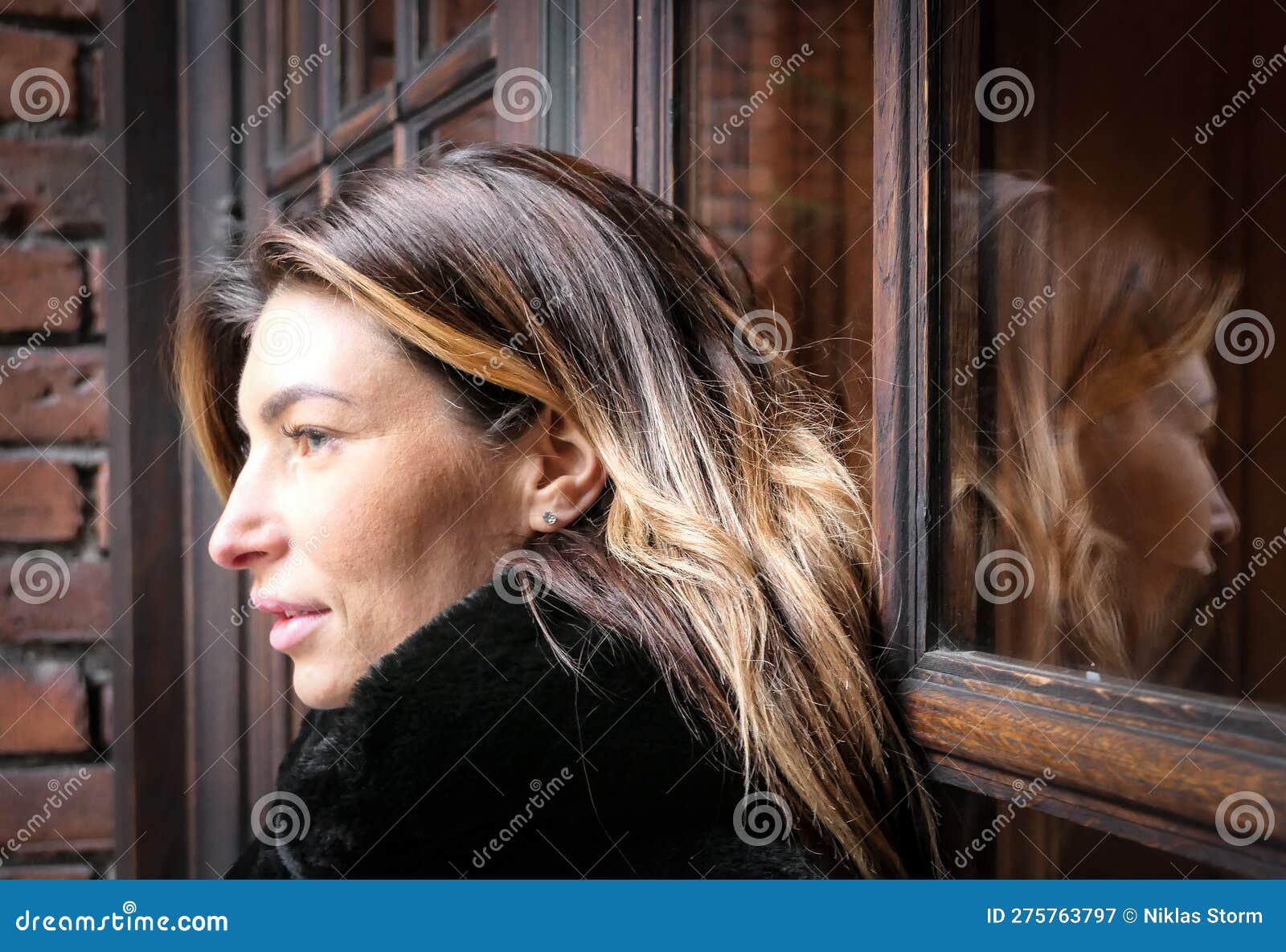 A Young Woman Standing at a Window Stock Image - Image of city, fashion ...