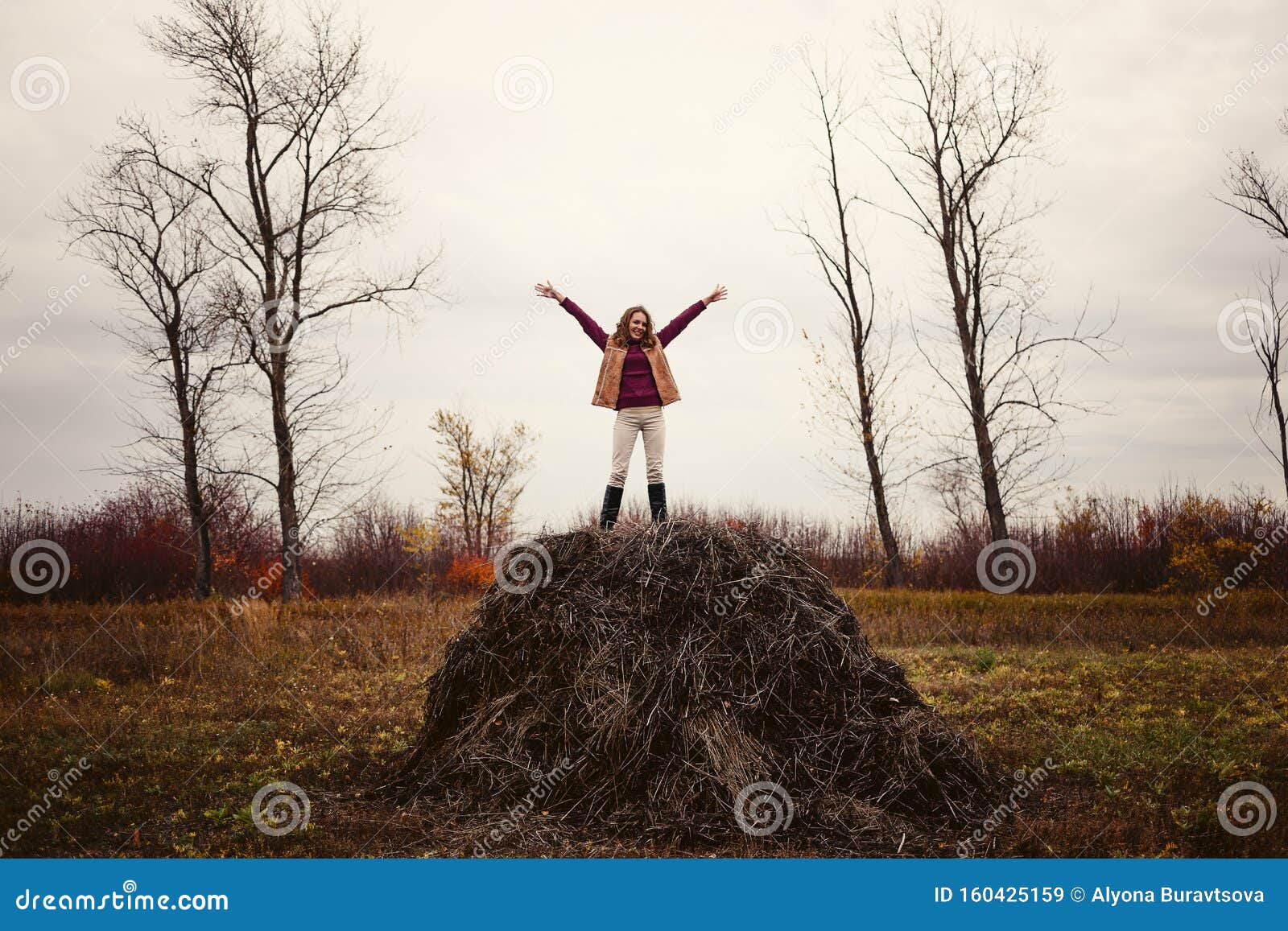 A Young Woman Stands on a Haystack in the Fall Stock Image - Image of ...