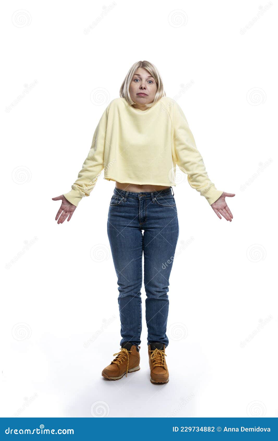 A Young Woman Stands And Throws Up Her Hands In Surprise Blonde In A