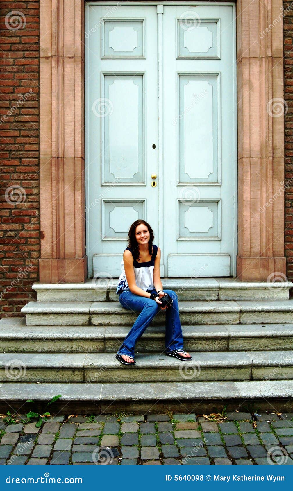 Young Woman on Steps in Front of Door Stock Photo - Image of person ...