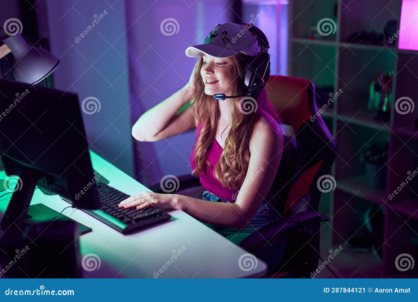 Young Woman Streamer Using Computer and Headphones at Gaming Room Stock ...