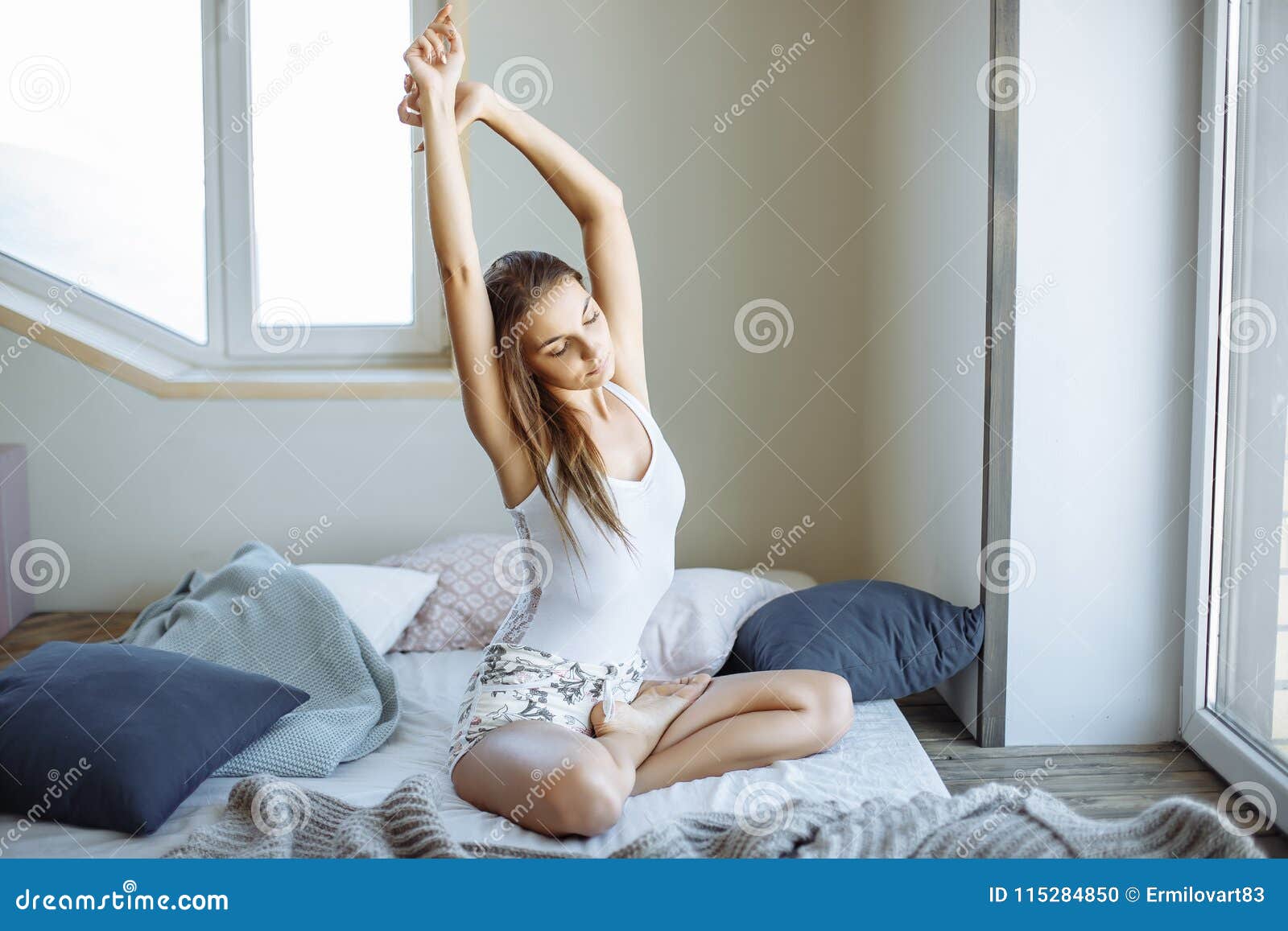 Young Woman Stretching on Bed in Morning. Stock Photo - Image of ...