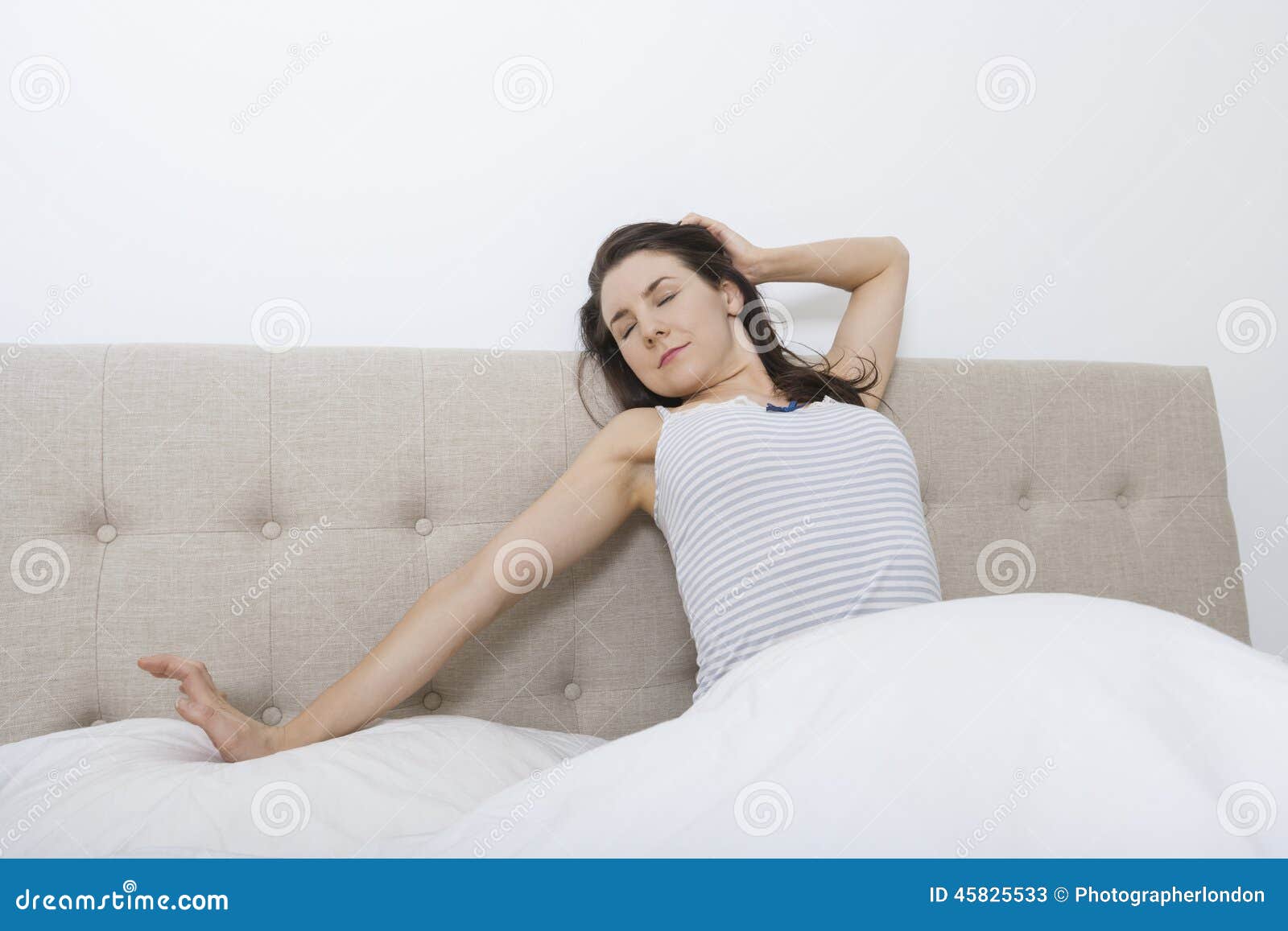 Young Woman Stretching in Bed Stock Image - Image of adult, view: 45825533