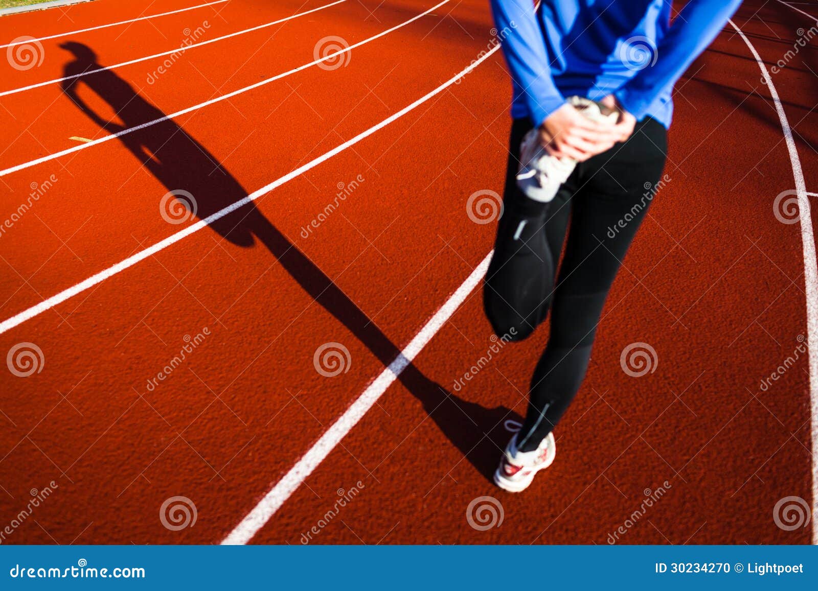 Young Woman Stretching before Her Run Casts Stock Photo - Image of ...