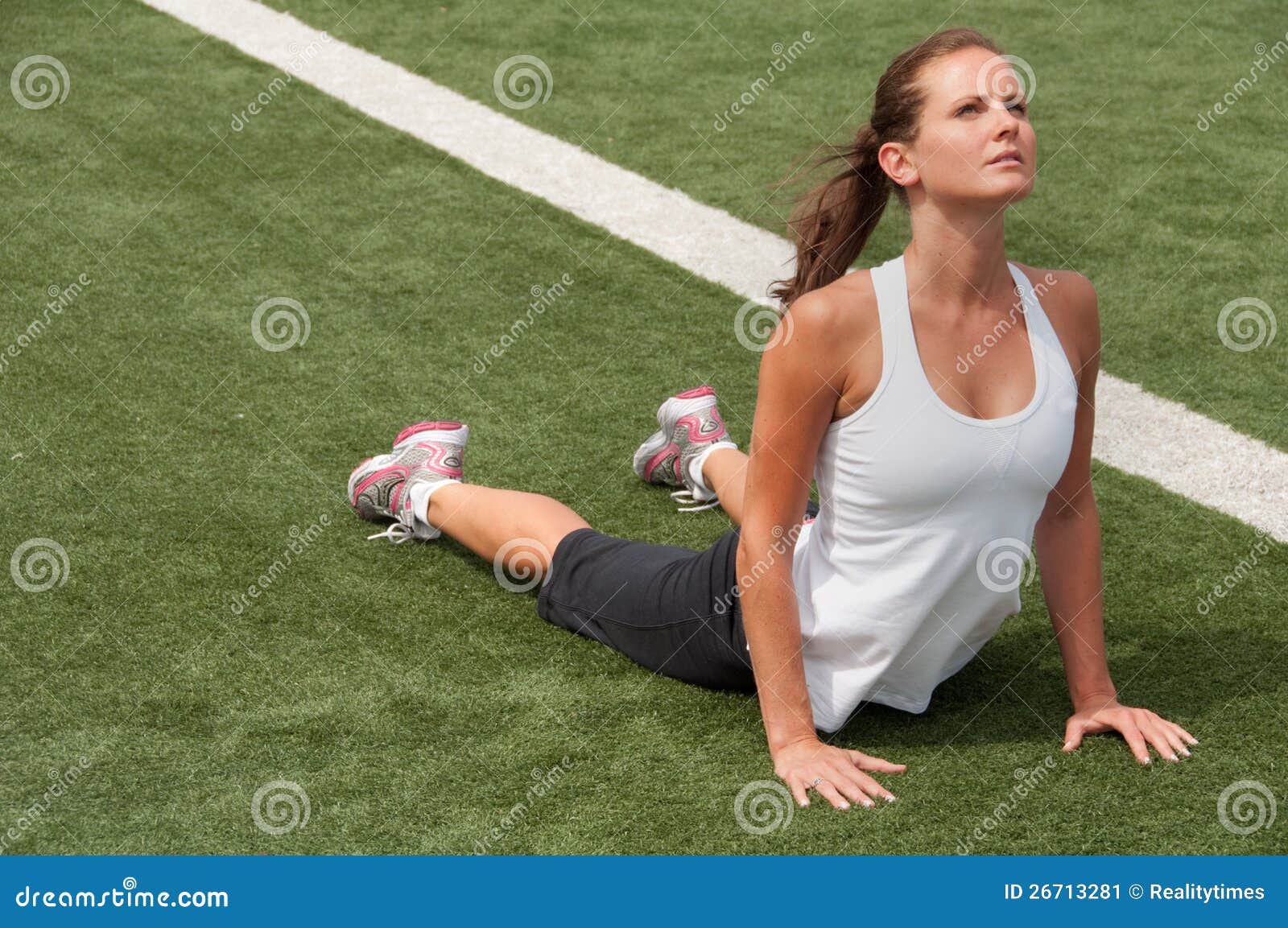 Young Woman Stretching on Playing Field Stock Image - Image of ...