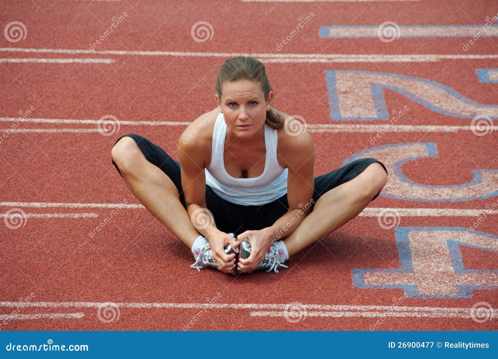 Young Woman Stretching on Track Stock Image - Image of stretching ...
