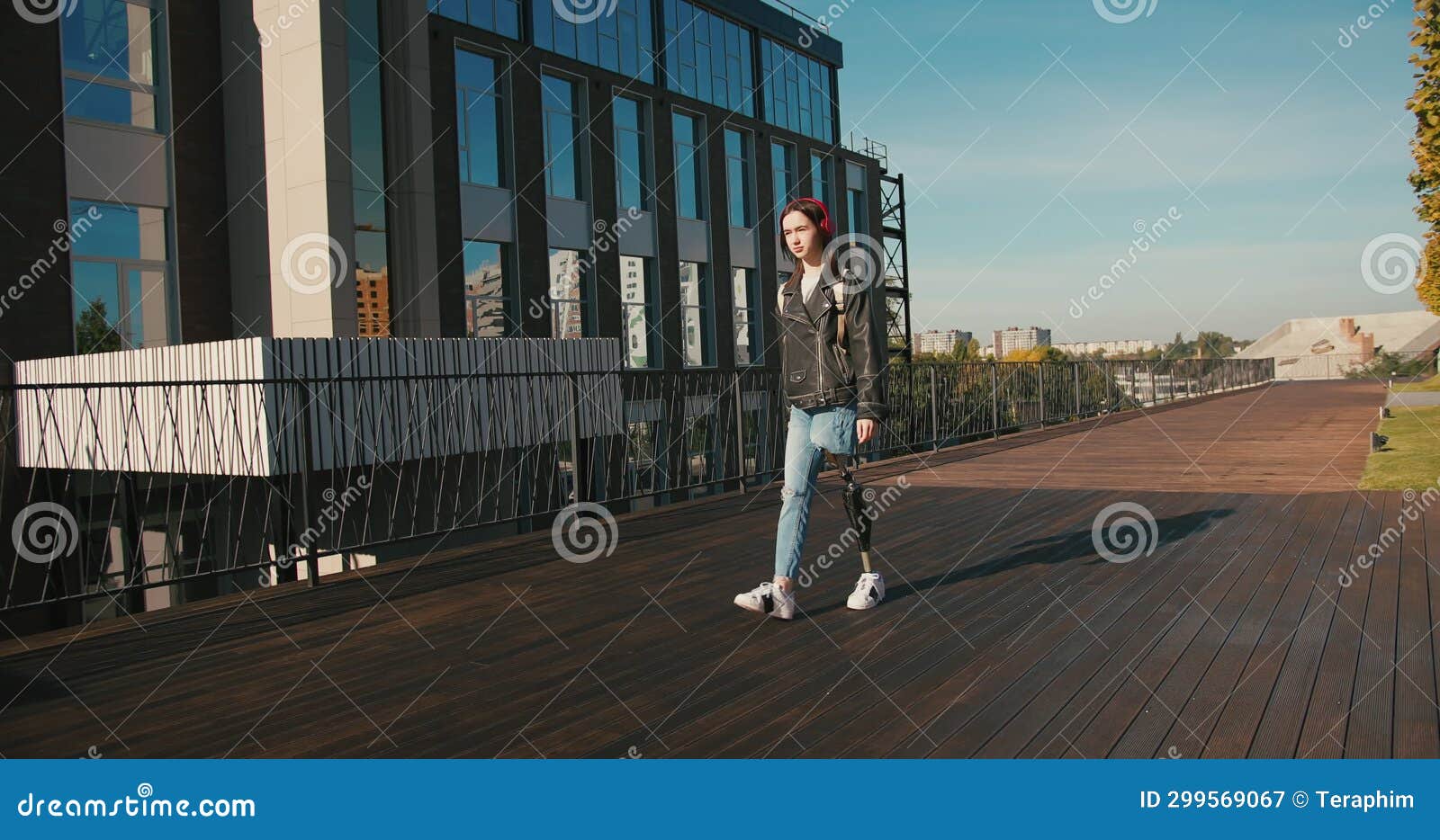 Young Woman Student with Prosthetic Leg Walking in University Campus ...