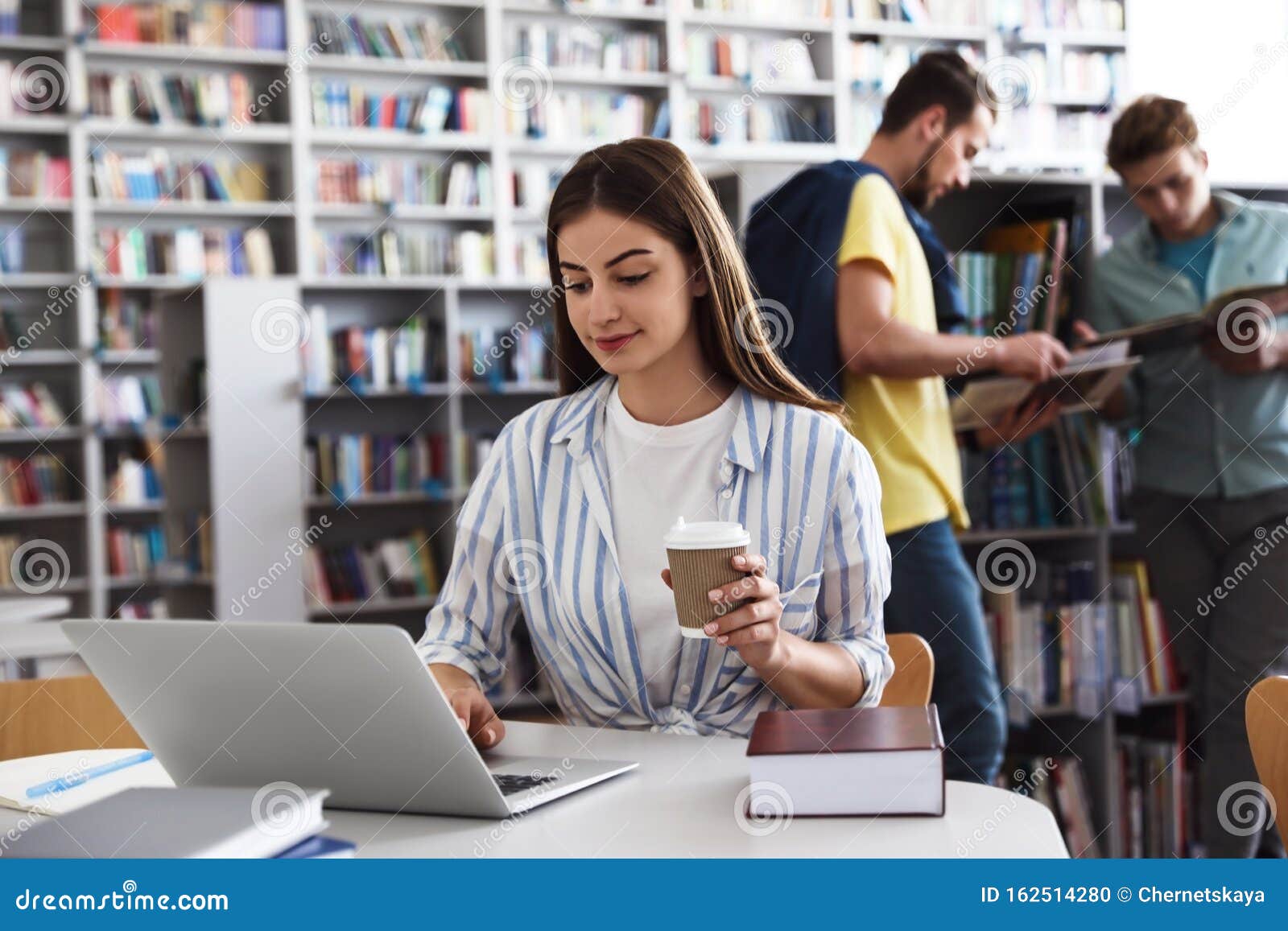 Young Woman Studying at Table in Library Stock Photo - Image of modern ...