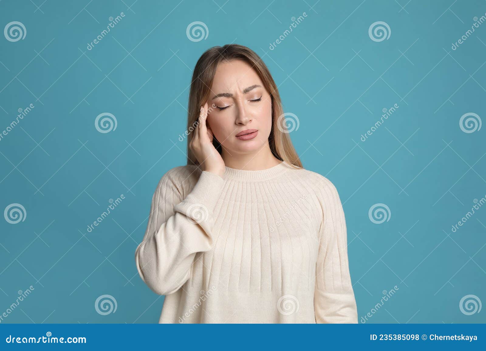 Young Woman Suffering from Headache on Light Blue Background Stock ...
