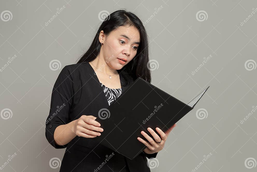 Young Woman in Suit with Dumbfounded Expression while Holding and ...