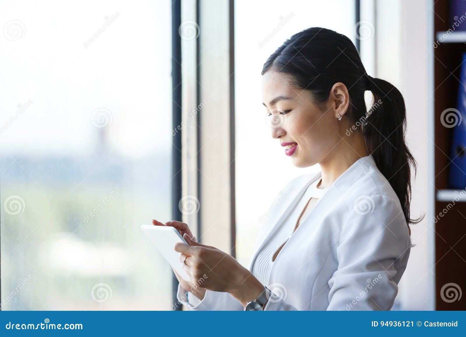 Young woman with tablet stock image. Image of indoors - 94936121