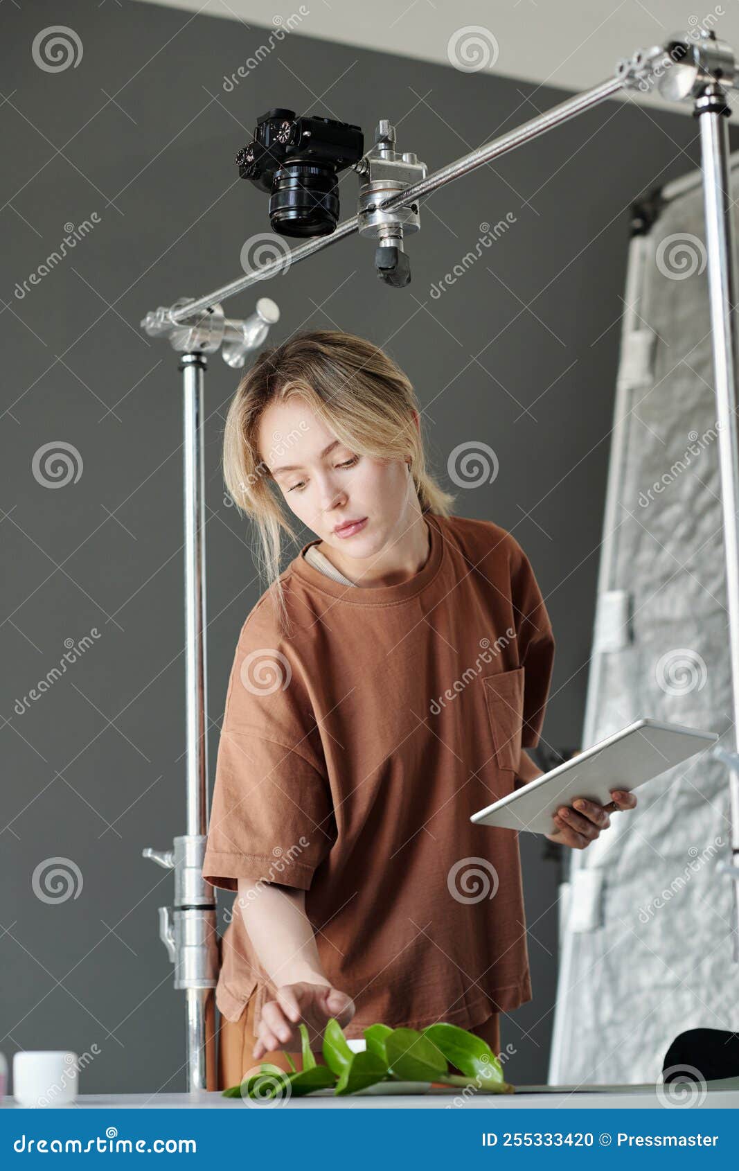 Young Woman with Tablet Bending Over Table while Making Composition ...