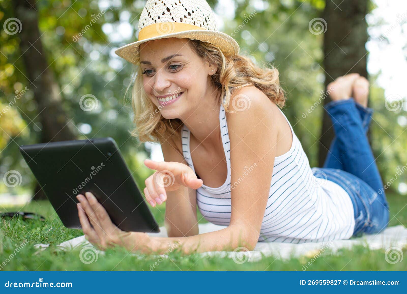 Young Woman with Tablet Computer Lying on Lawn Stock Image - Image of ...