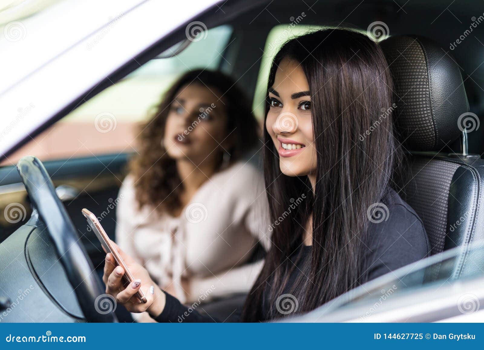 Young Woman Takes Control of a Car while the Driver Using a Mobile ...