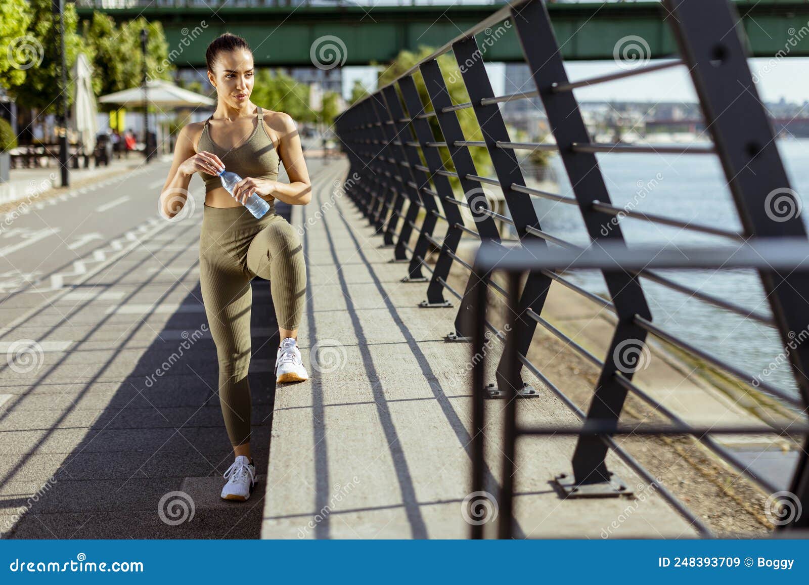 Young Woman Taking a Break during Exercise on the River Promenade Stock ...