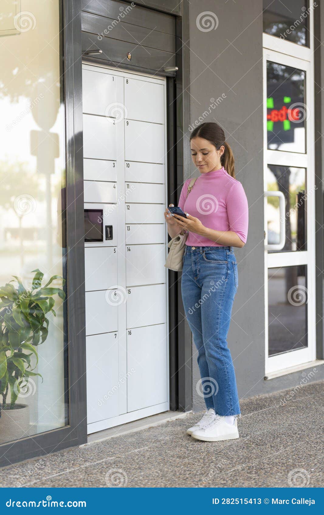 Young Woman Taking a Package Out of an Automatic Mailbox Stock Image ...
