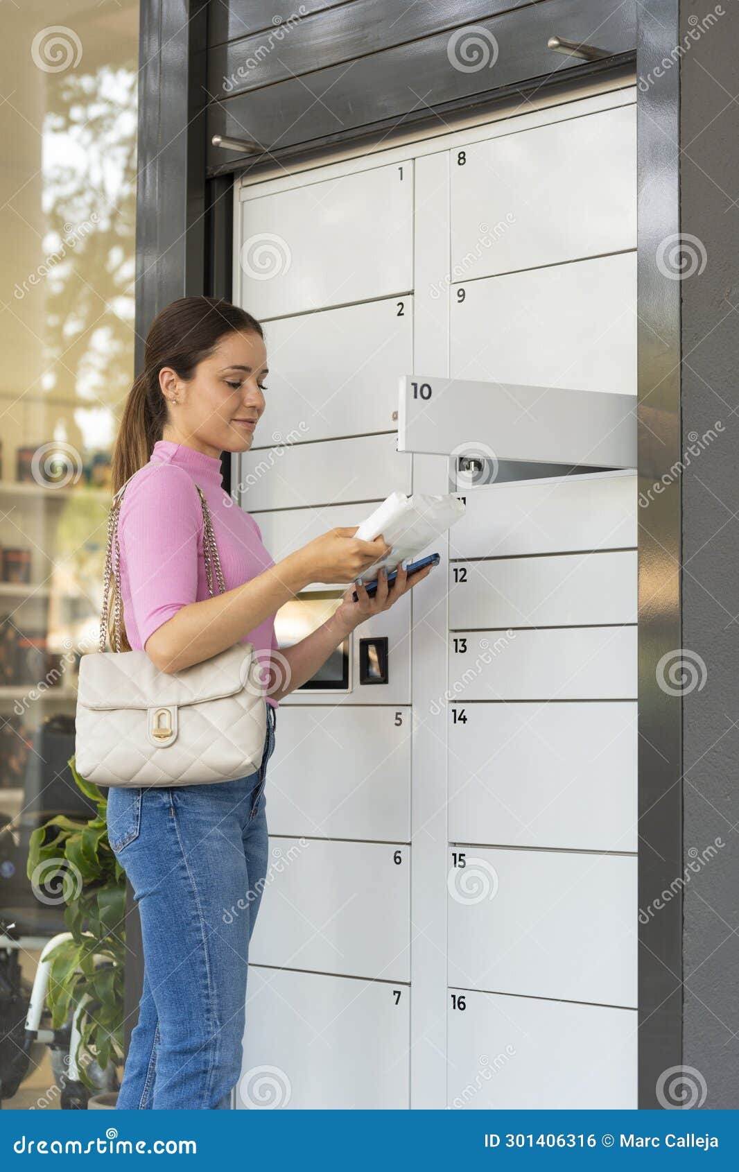Young Woman Taking a Package Out of an Automatic Mailbox Stock Photo ...