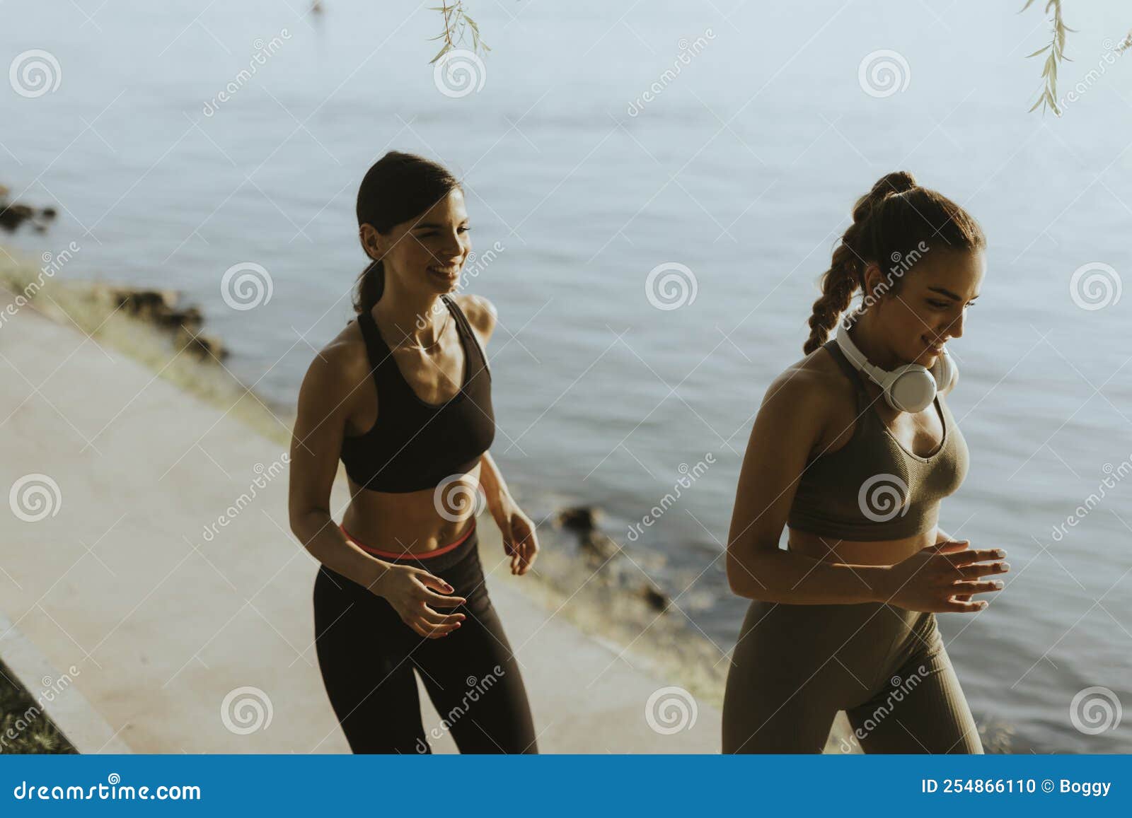 Young Woman Taking Running Exercise by the River Promenade Stock Photo ...
