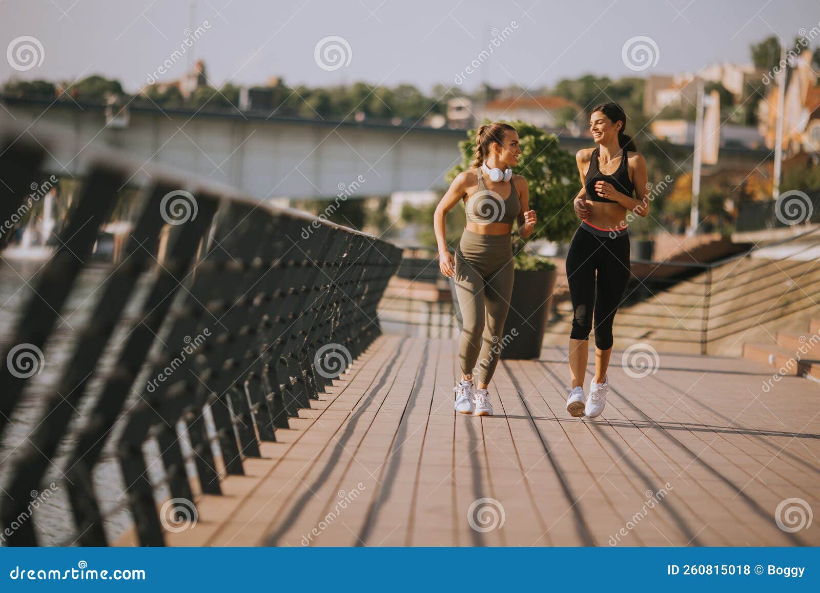 Young Woman Taking Running Exercise by the River Promenade Stock Photo ...