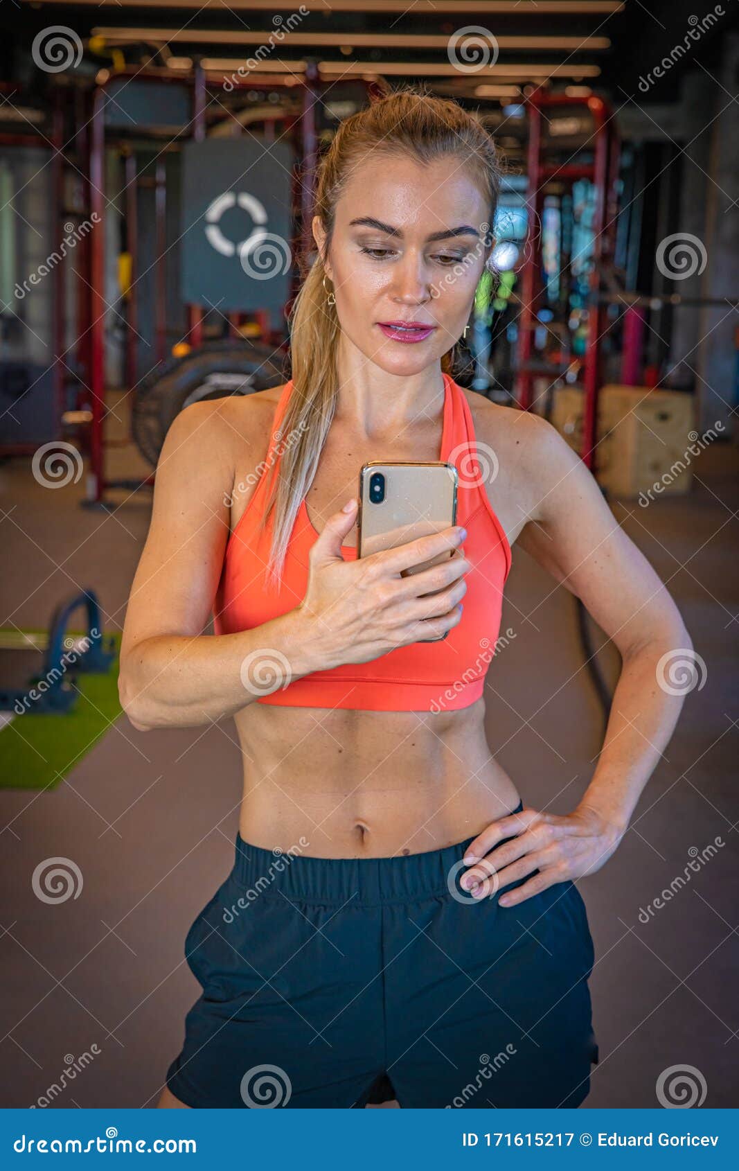 Young Woman Taking Selfie Photo By Mirror After Exercising At The Gym