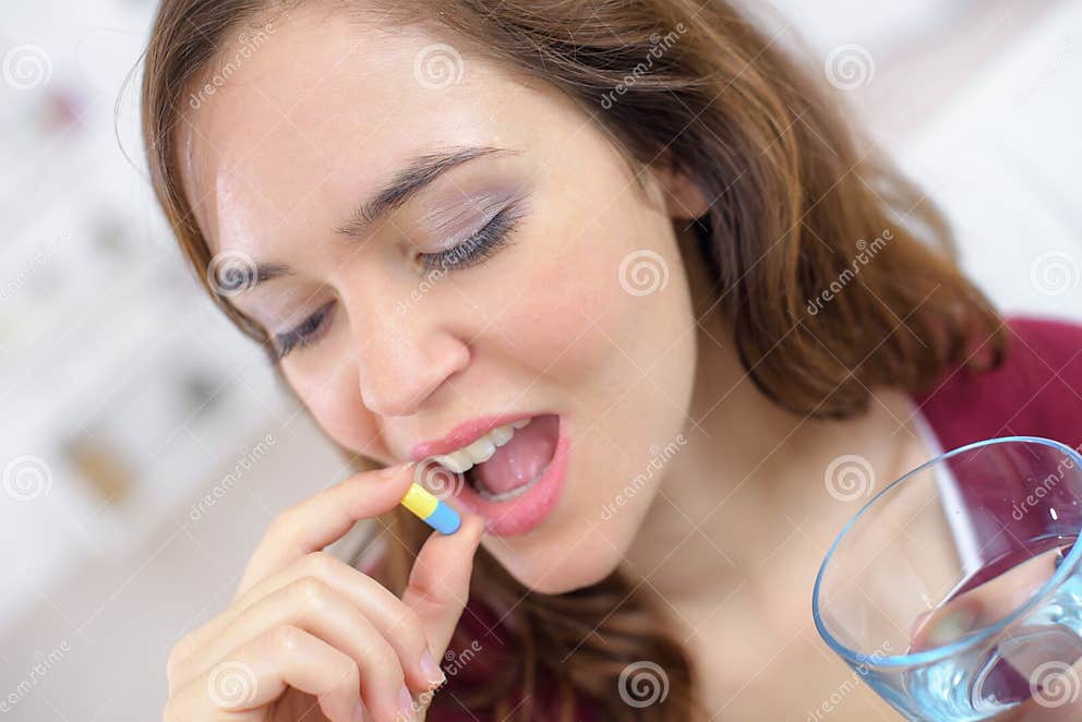 Young woman taking tablet stock photo. Image of medical - 103743144