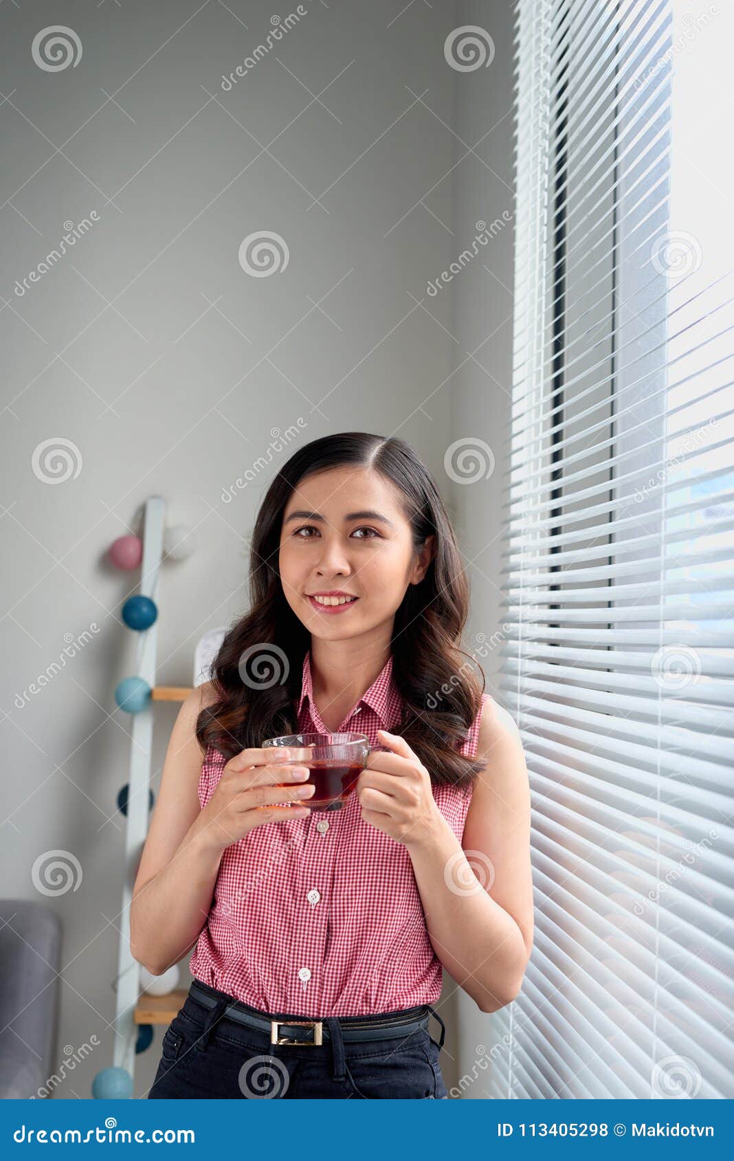 Young Woman Taking a Tea Break Standing by the Office Window. Stock ...