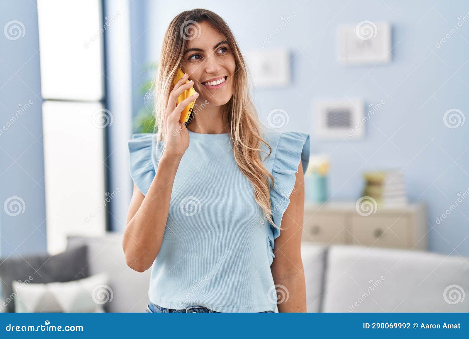 Young Woman Talking on Smartphone Standing at Home Stock Photo - Image ...