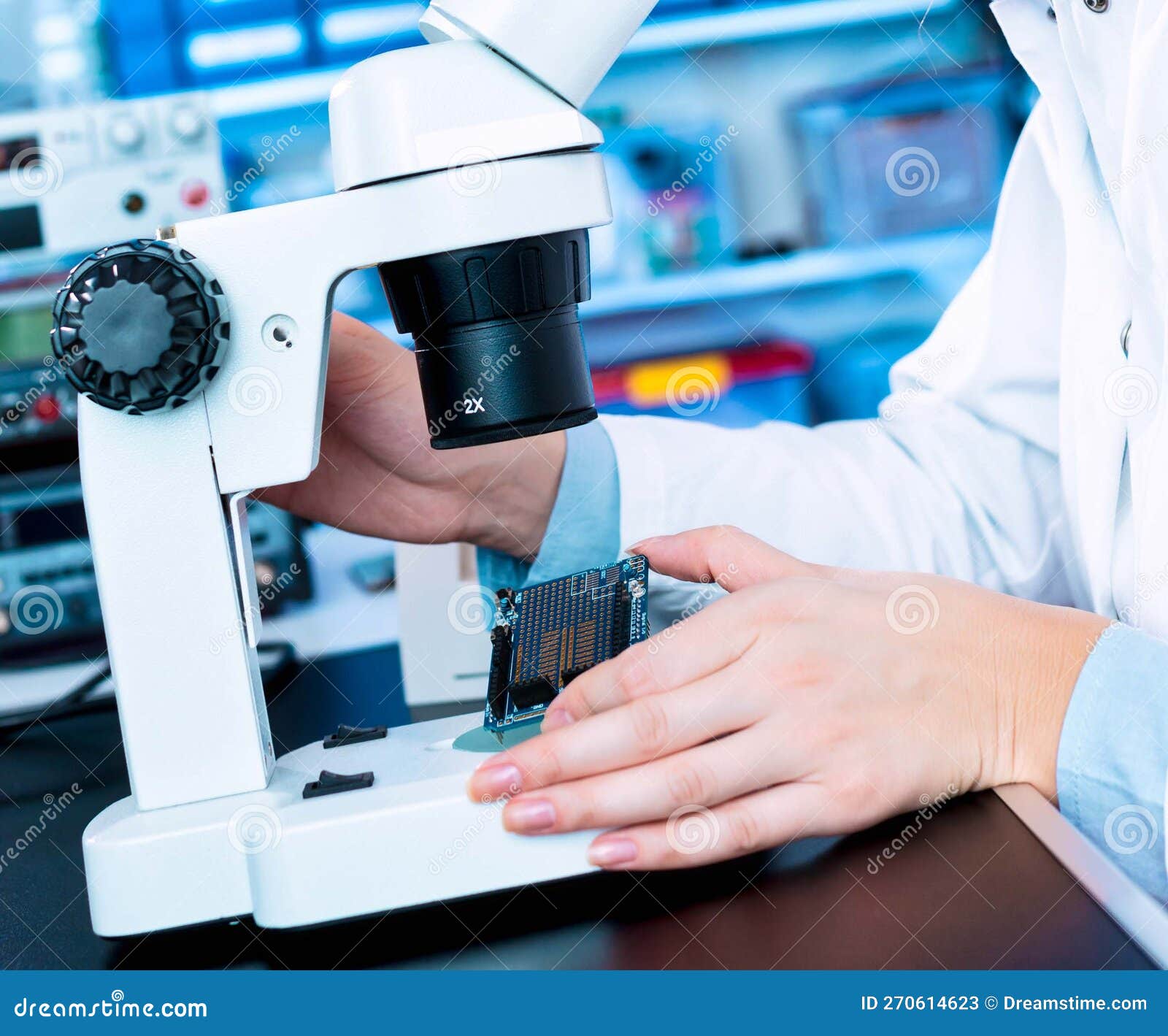 A Young Woman is Testing an Electronic Module for the Production of ...