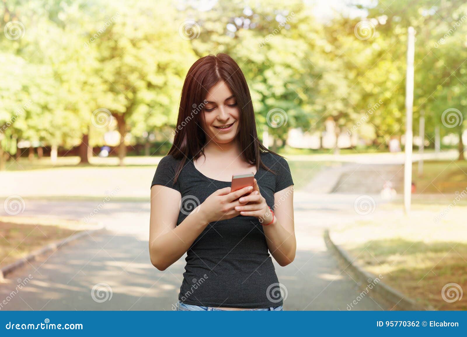 Young woman texting stock photo. Image of blond, good - 95770362