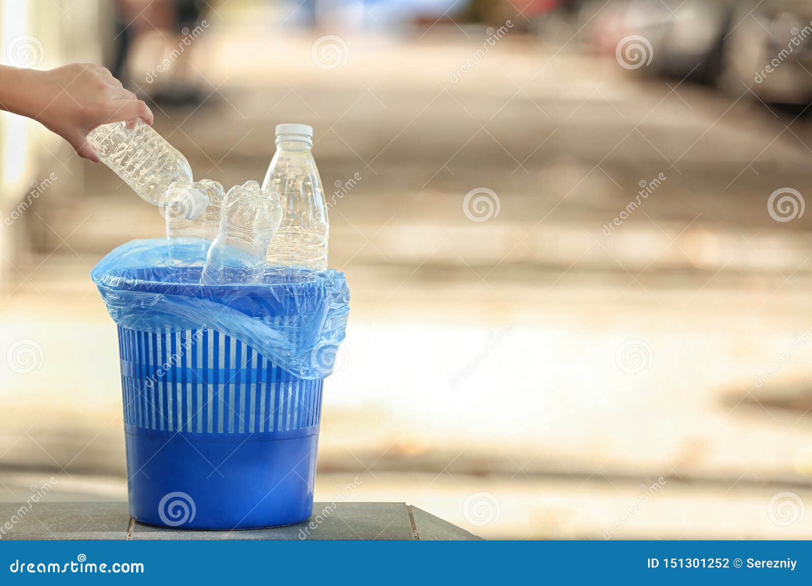 Young Woman Throwing Plastic Bottle into Litter Bin Outdoors Stock ...