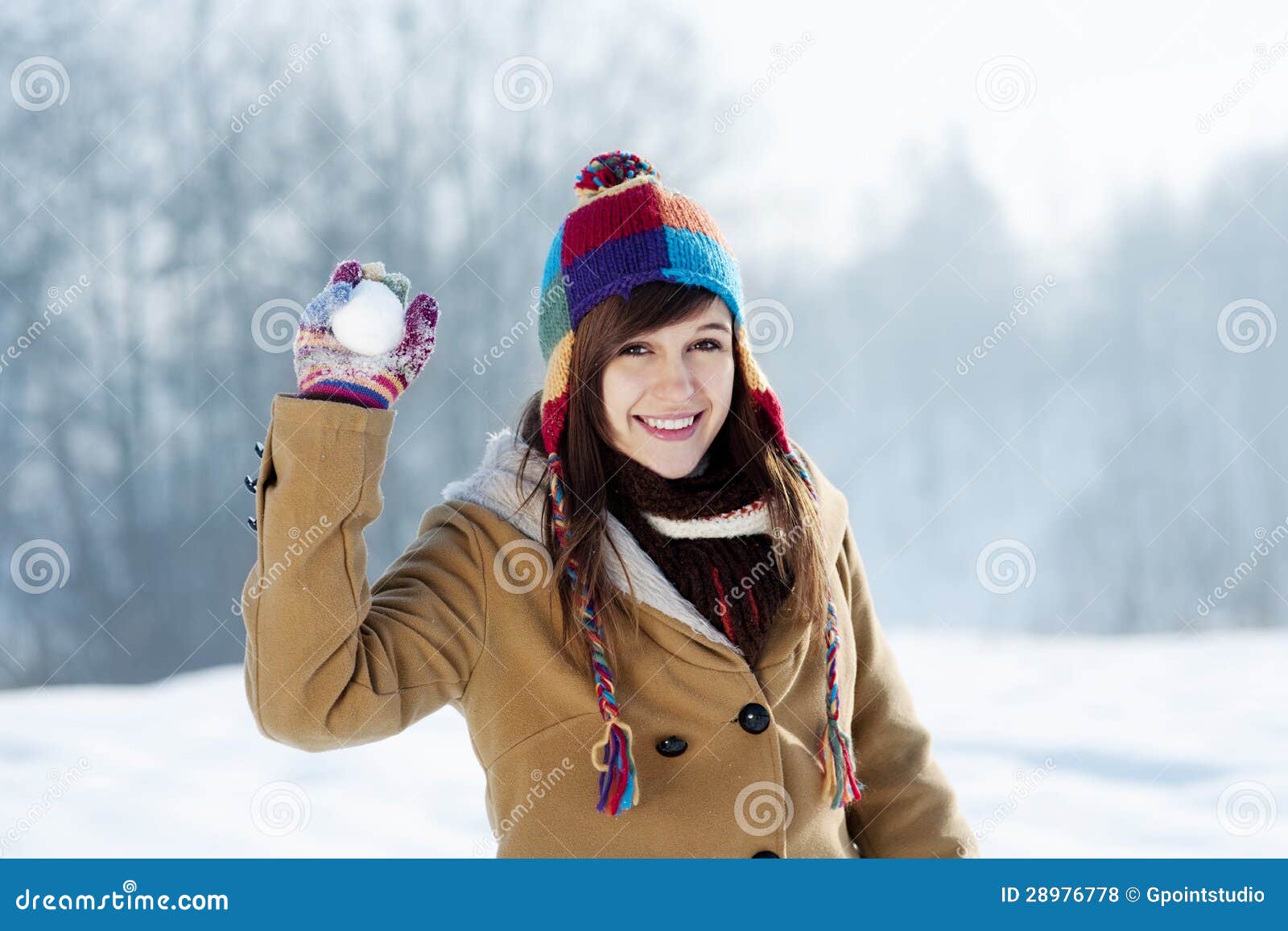 Young Woman Throwing Snowball Stock Photo - Image of color, happiness ...