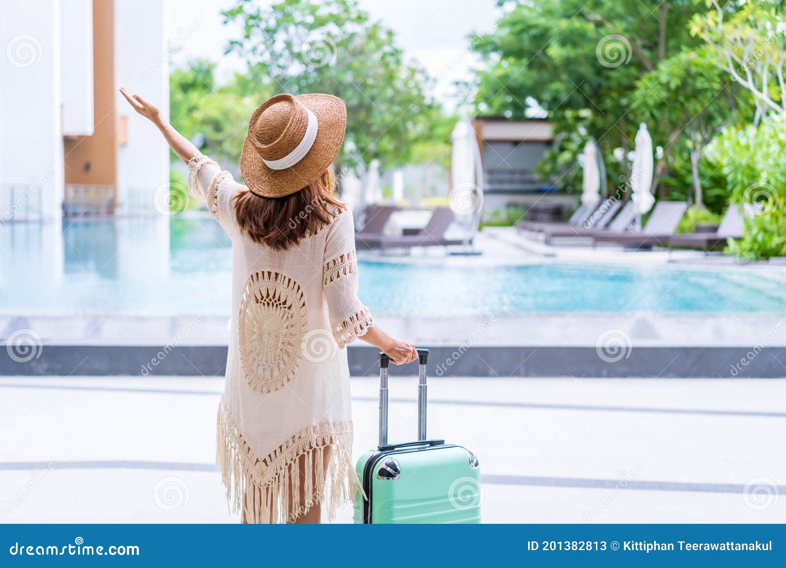 Young Woman Traveler Enjoying A Summer Vacation At Swimming Pool In