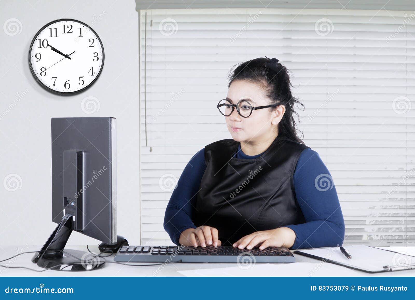 Young Woman Typing on Keyboard in Office Stock Image - Image of looking ...