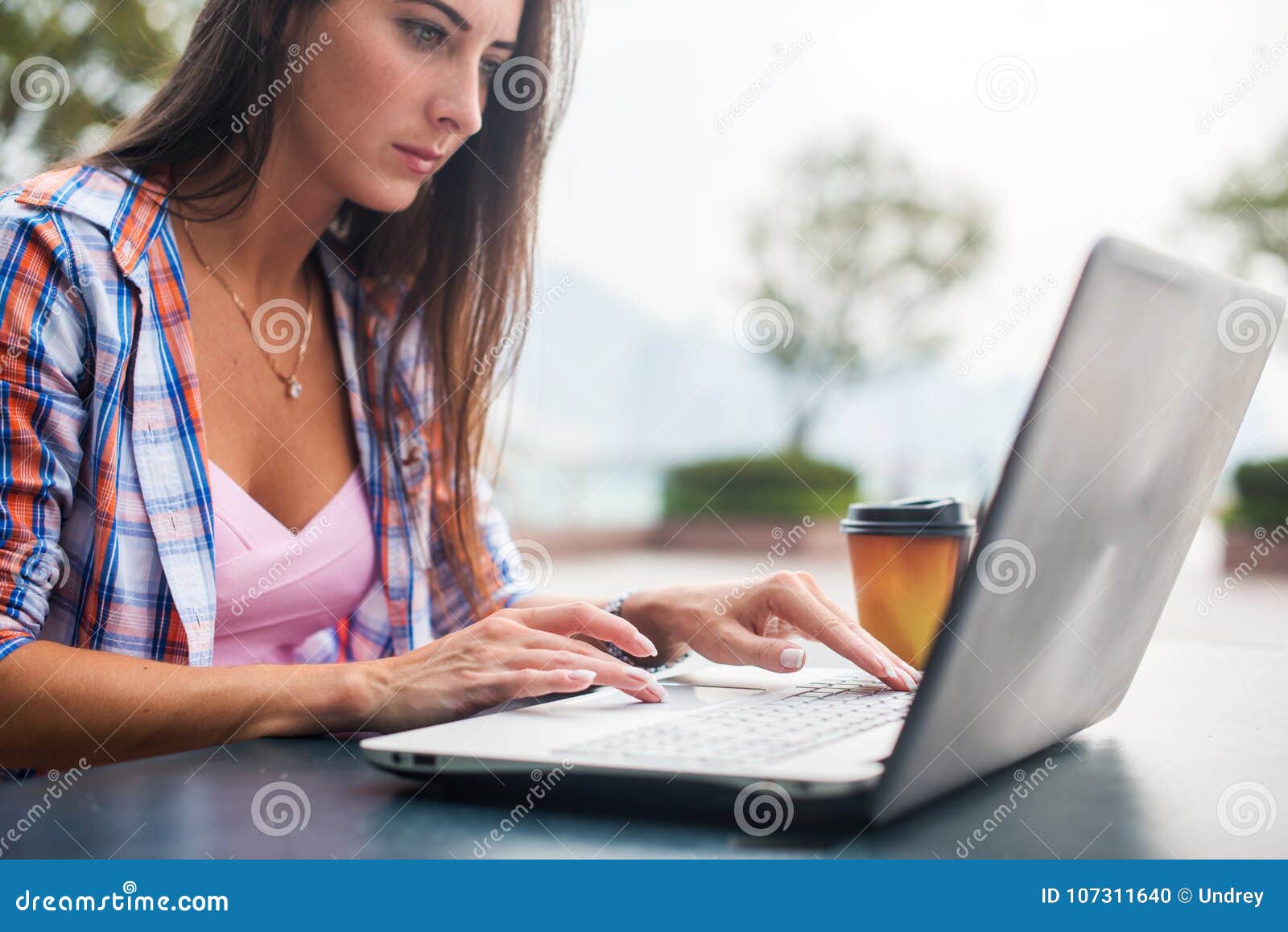 Young Woman Typing on a Laptop Studying or Working in the Park Stock ...
