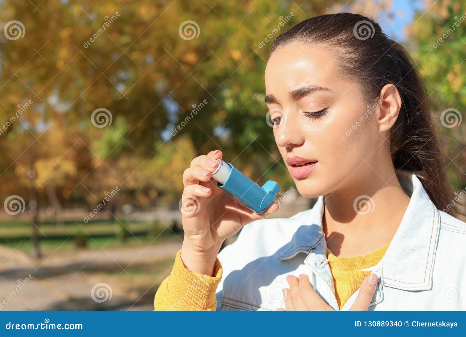 Young Woman Using Asthma Inhaler Outdoors Stock Photo - Image of ...