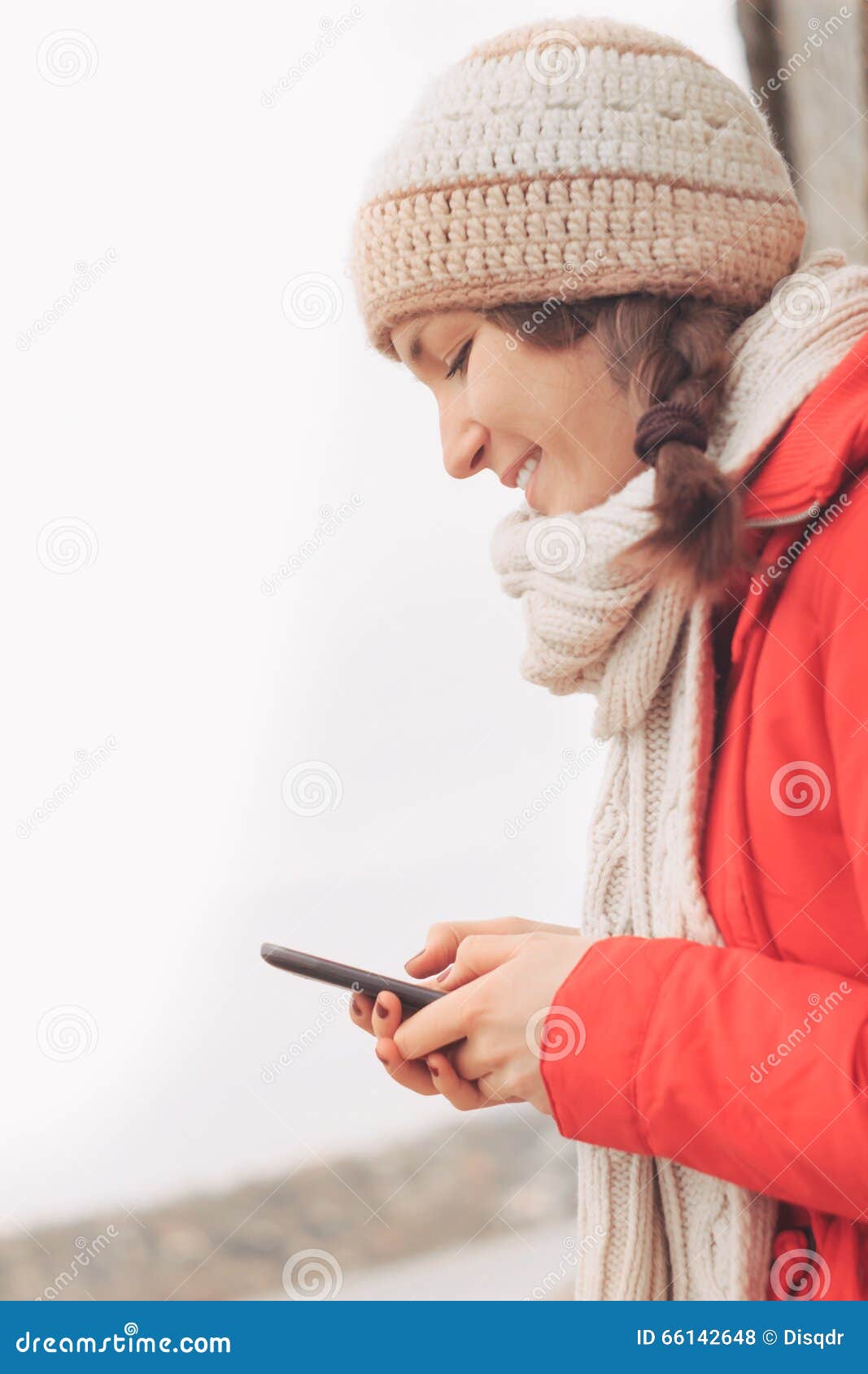 Young Woman Using Cell Phone Texting, Typing and Smiling Stock Photo ...