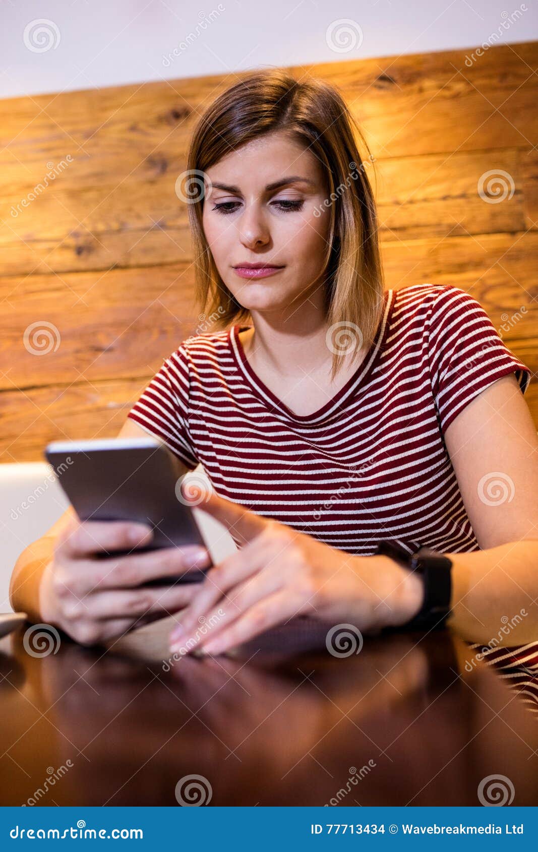 Young Woman Using Cellphone at Table Stock Photo - Image of leisure ...