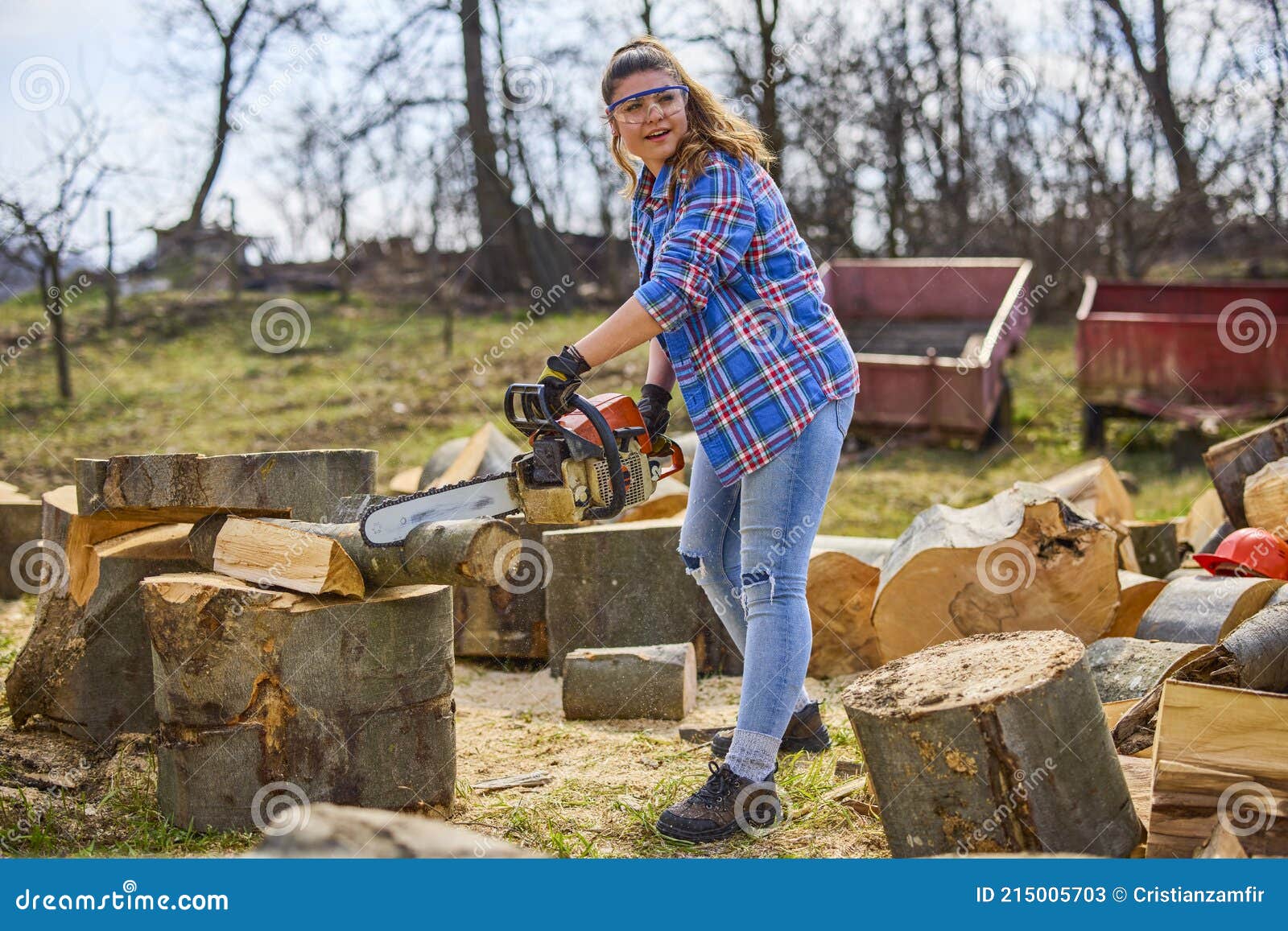 Young Woman Using Chainsaw To Cut a Log Stock Image - Image of female ...