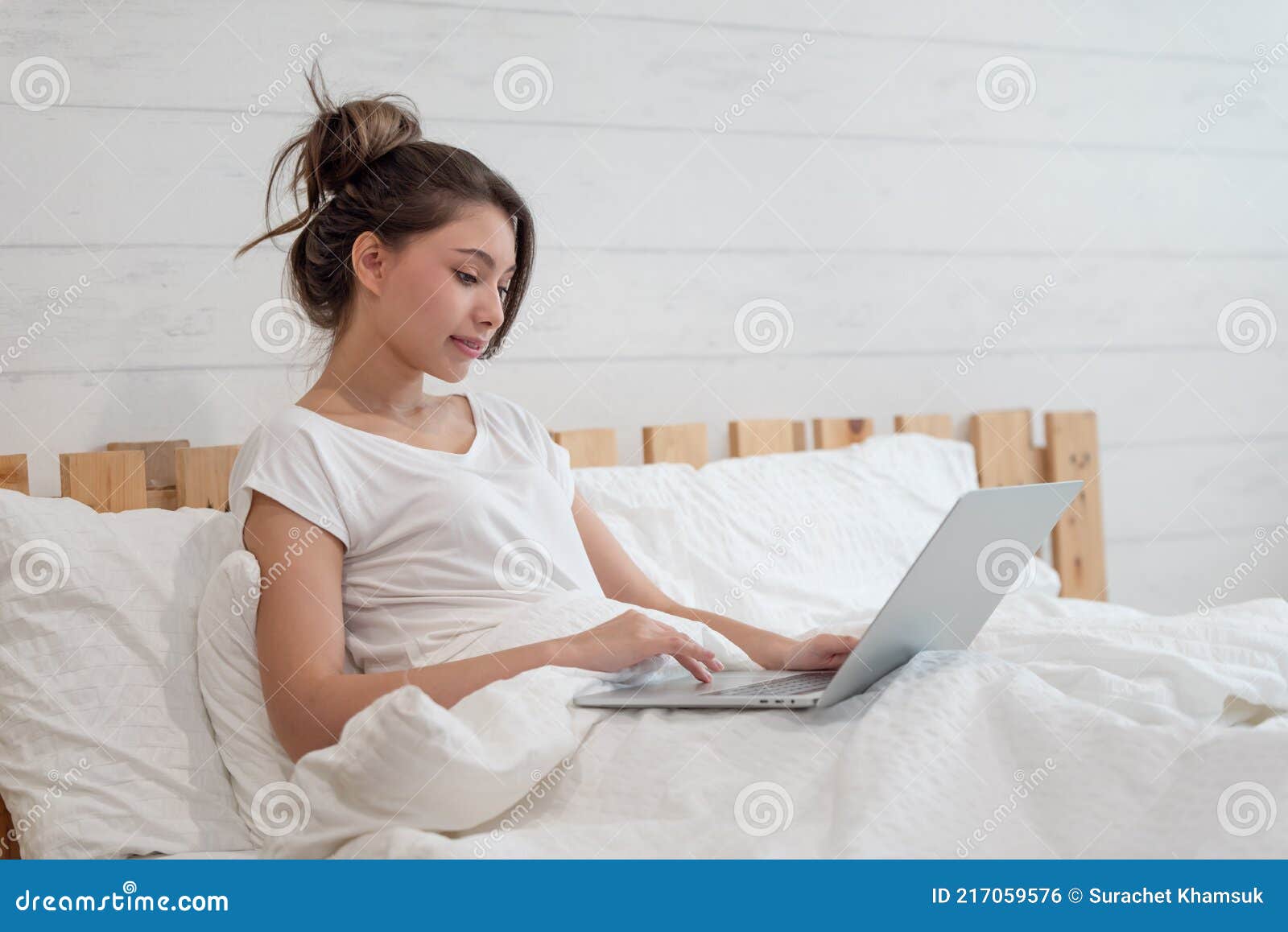 Young Woman Using Computer in Bedroom Stock Photo - Image of beautiful ...