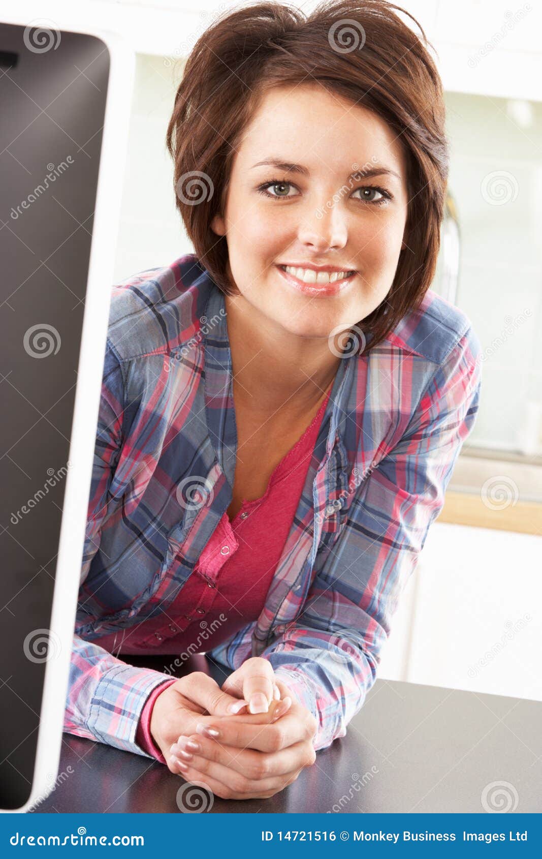 Young Woman Using Computer in Modern Kitchen Stock Photo - Image of ...