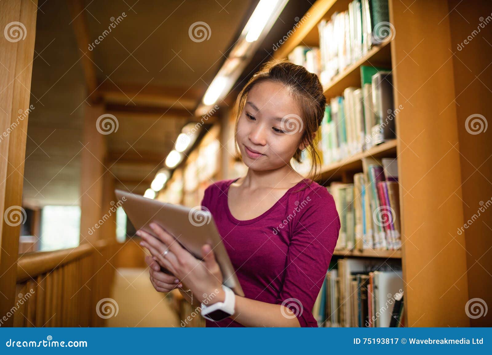 Young Woman Using Digital Tablet in Library Stock Image - Image of ...