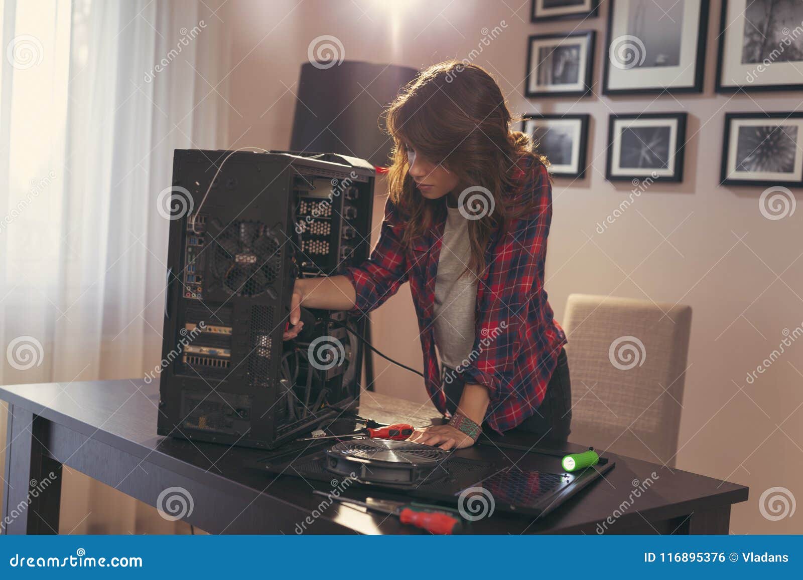 Young Woman Using Electrical Screwdriver To Fix a Computer Stock Photo ...