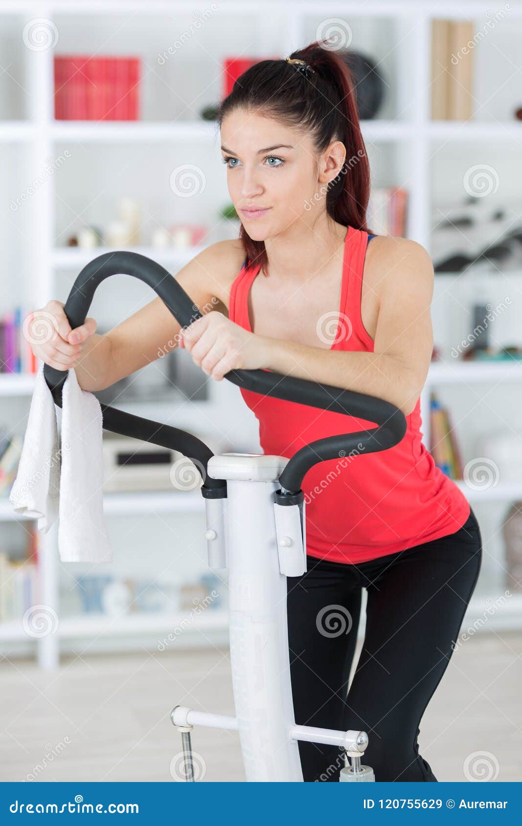 Young Woman Using Exercise Machine at Home Stock Image - Image of ...