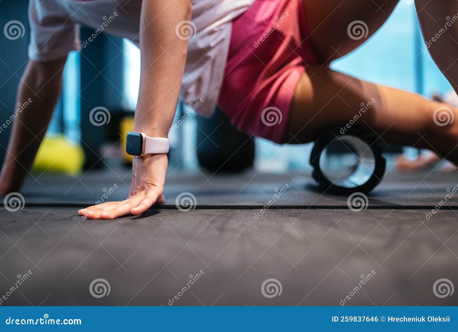 Young Woman Using a Foam Roller while Doing Stretching Exercises Stock ...