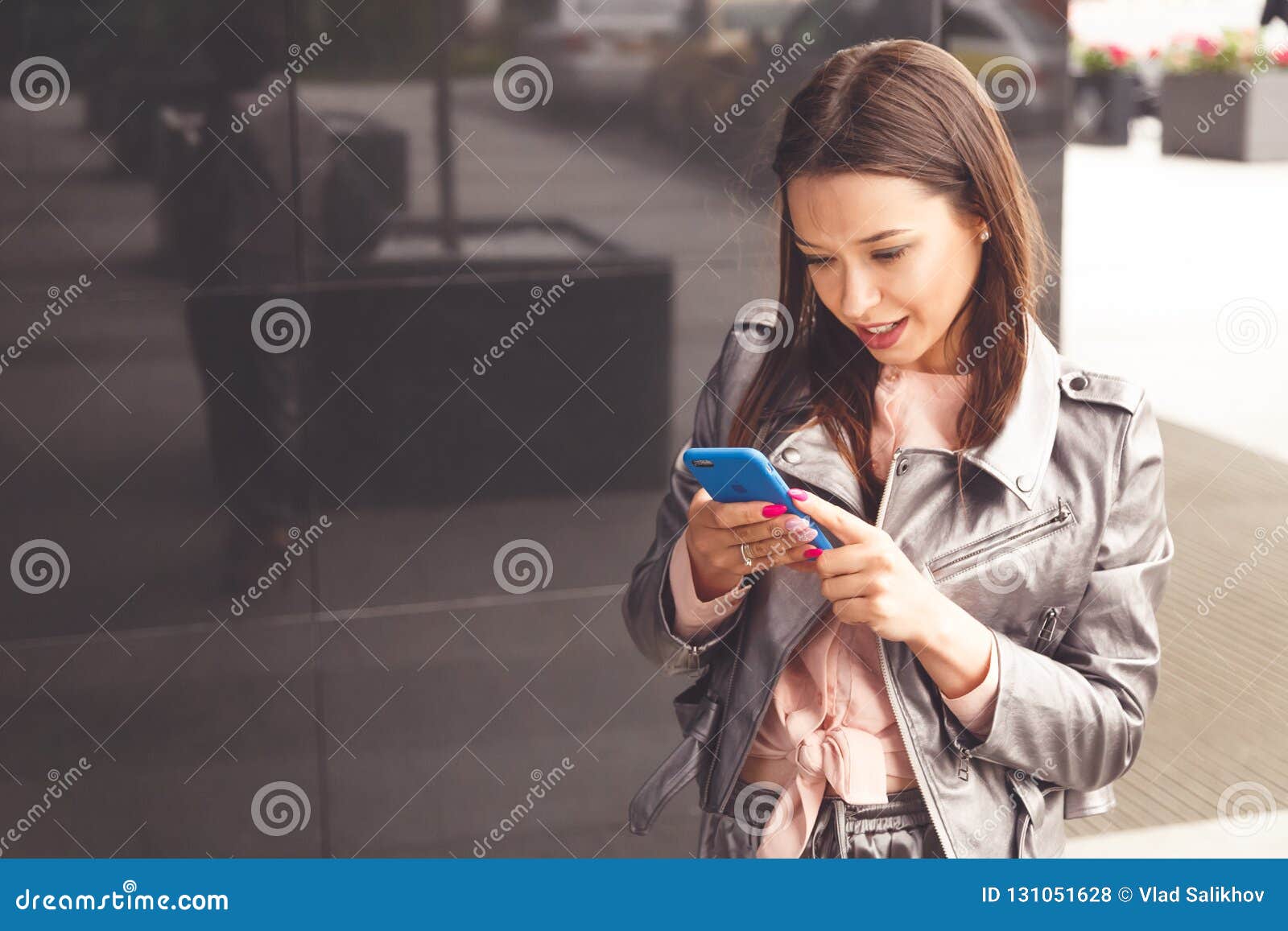 Young Woman Using Her Phone at the Office Building Stock Photo - Image ...