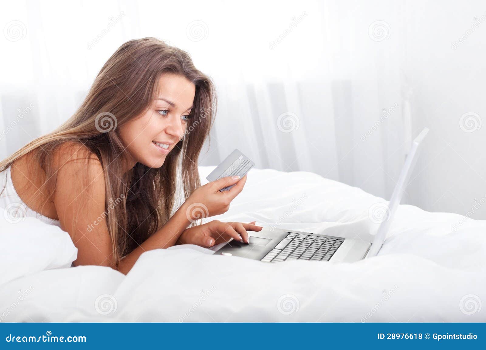 Young Woman Using Laptop in Bed Stock Photo - Image of laptop, leaning ...